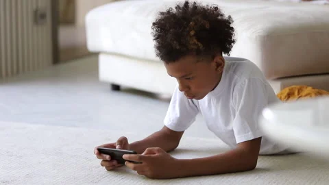 African American boy is using smartphone... | Stock Video | Pond5