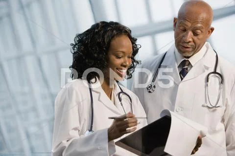 African Doctors Reviewing Medical Chart - Stock Image - Everypixel