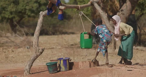 African girls fetching water in Mali, We... | Stock Video | Pond5