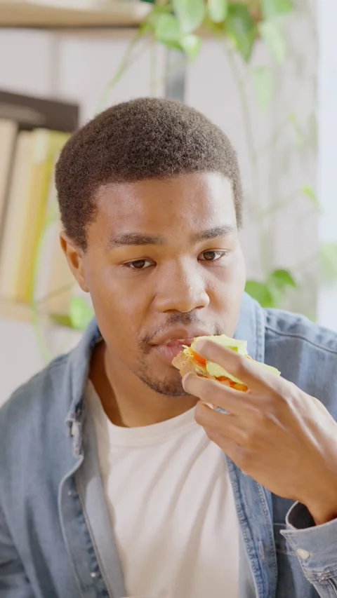 African man eating a healthy toast at ho... | Stock Video | Pond5
