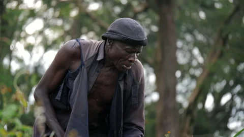 African Man with ripped clothes digging ... | Stock Video | Pond5