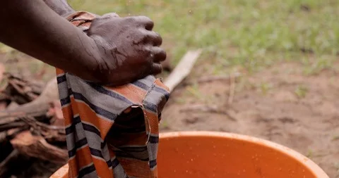 An African rural woman washing clothes b... | Stock Video | Pond5