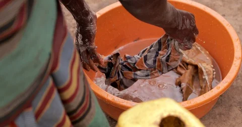 An African rural woman washing clothes b... | Stock Video | Pond5