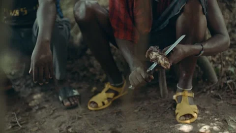 An African sitting in a squat and wearin... | Stock Video | Pond5