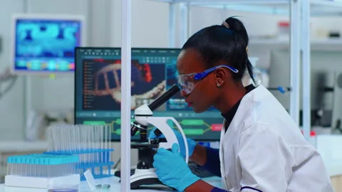 African woman biochemist using microscop... | Stock Video | Pond5