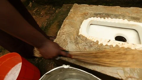 African Woman cleaning a pit latrine in ... | Stock Video | Pond5