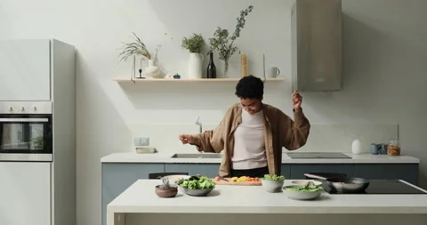 African woman dance while cook in modern... | Stock Video | Pond5