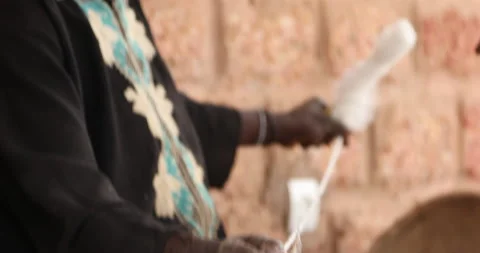 African woman spinning cotton wool into ... | Stock Video | Pond5