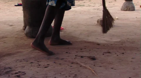 African woman sweeping the ground. | Stock Video | Pond5