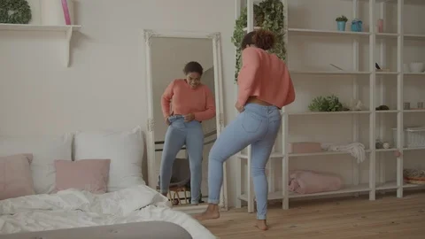 African woman trying to squeeze into tig... | Stock Video | Pond5