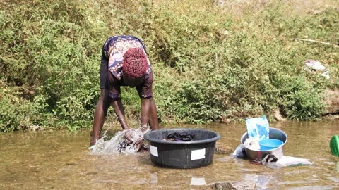 African woman washing clothes at the Riv... | Stock Video | Pond5
