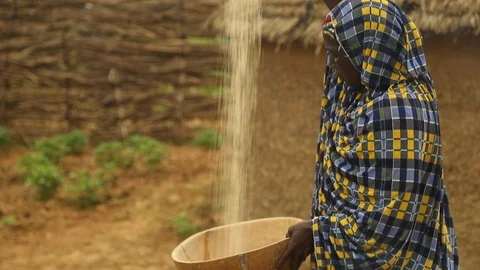 African woman winnowing grain in a calab... | Stock Video | Pond5