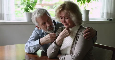 Aged wife crying husband hugs her comfor... | Stock Video | Pond5