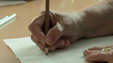 Aged woman's hands drawing flowers on pa... | Stock Video | Pond5