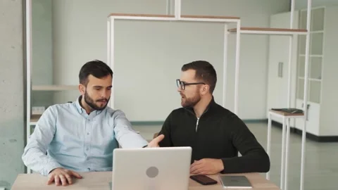 aggressive Two men sitting in the office... | Stock Video | Pond5
