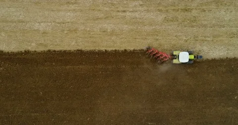 AGRICULTURE - Wide shoot of tractor plow... | Stock Video | Pond5