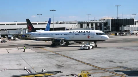 Air Canada plane being pushed from the g... | Stock Video | Pond5