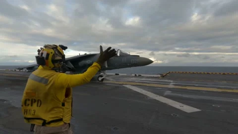 Aircraft handler directing AV-8B Harrier... | Stock Video | Pond5