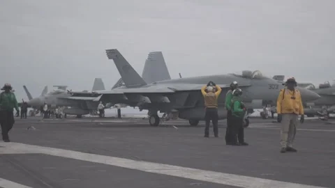 Aircraft handler guiding F/A-18 Hornet a... | Stock Video | Pond5
