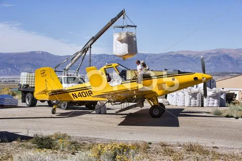 Aircraft loading with fuel and seeds for wildfire recovery.jpg ...
