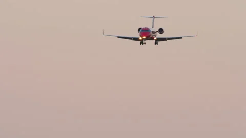 Aircraft with red livery in the sunset s... | Stock Video | Pond5