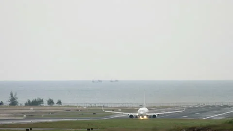 Airliner on the runway, behind the sea b... | Stock Video | Pond5
