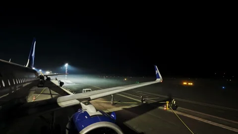 Airplane boarding at night with runway l... | Stock Video | Pond5