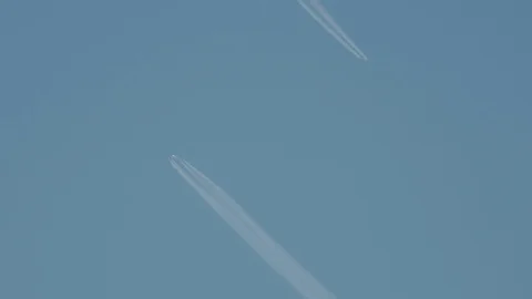 Airplane in flight, making a white strip... | Stock Video | Pond5