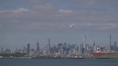 Airplane flying New York City skyline bu... | Stock Video | Pond5