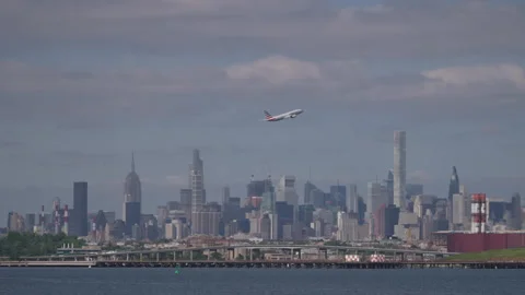 Airplane flying New York City skyline bu... | Stock Video | Pond5