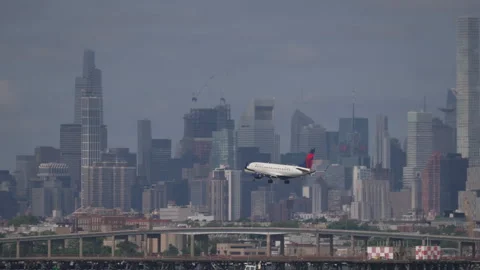 Airplane flying New York City skyline bu... | Stock Video | Pond5