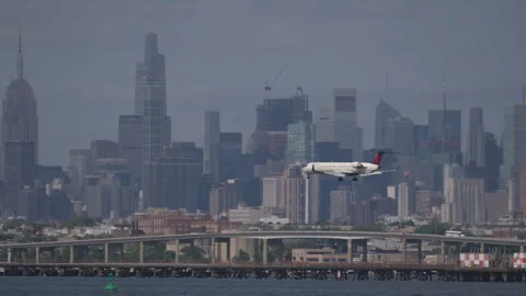 Airplane flying New York City skyline bu... | Stock Video | Pond5