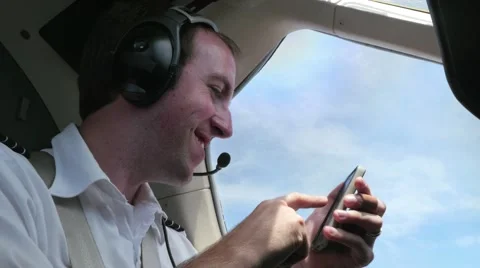 Airplane pilot with Cell Phone in Cockpi... | Stock Video | Pond5
