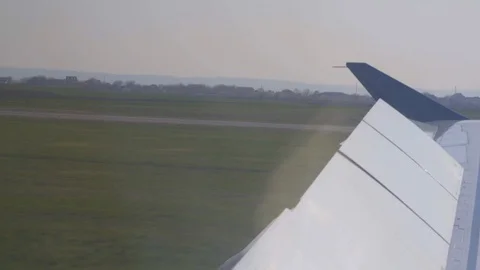 Airplane wing flaps up, break during lan... | Stock Video | Pond5