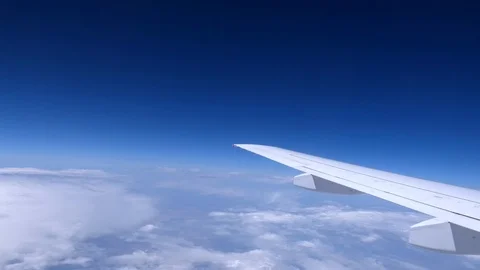 Airplane wing moving above white clouds ... | Stock Video | Pond5