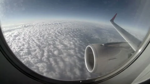 Airplane wing out of window on blue sky ... | Stock Video | Pond5