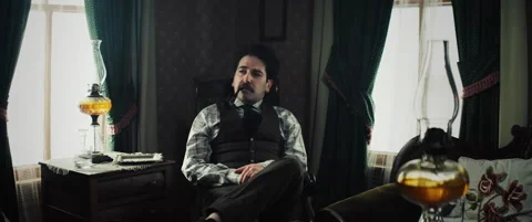 Albert Einstein smoking while sitting on... | Stock Video | Pond5