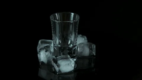 Alcohol with ice cubes on a black backgr... | Stock Video | Pond5