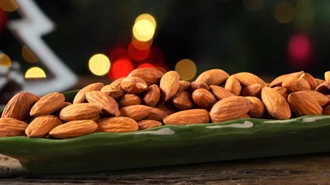 Almonds in a Christmas Tree Pot on a blu... | Stock Video | Pond5
