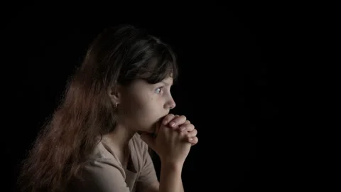 Alone praying child on black background. | Stock Video | Pond5