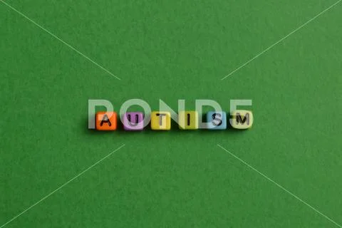 Alphabet letters with text AUTISM isolated on green background Stock ...