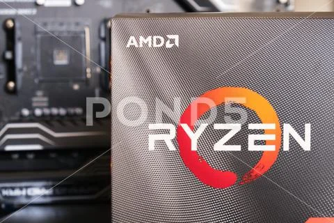 Photograph: AMD Ryzen CPU box in front of a motherboard. #122891002