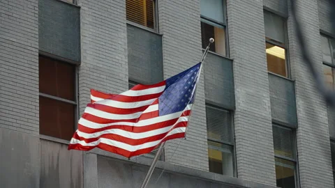 American flag waving on the building in ... | Stock Video | Pond5