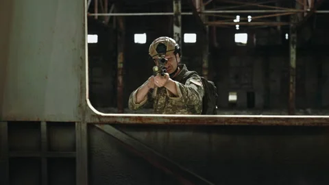 American soldier aiming through window o... | Stock Video | Pond5