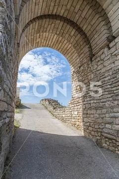 Ancient arch of a medieval wall. ~ Hi Res #230248803