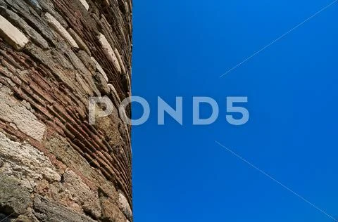 Ancient stone tower texture against blue sky Stock Photo #64726425