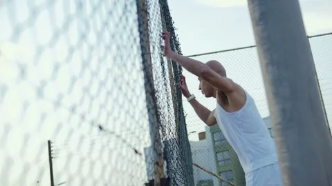 Angry bald man beats his hands on a grid... | Stock Video | Pond5