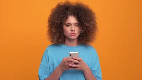 Angry blonde woman typing by mobile | Stock Video | Pond5