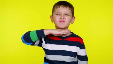 Angry child boy waves hand near neck, sh... | Stock Video | Pond5