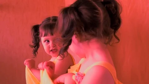 An angry child looks in the mirror. | Stock Video | Pond5